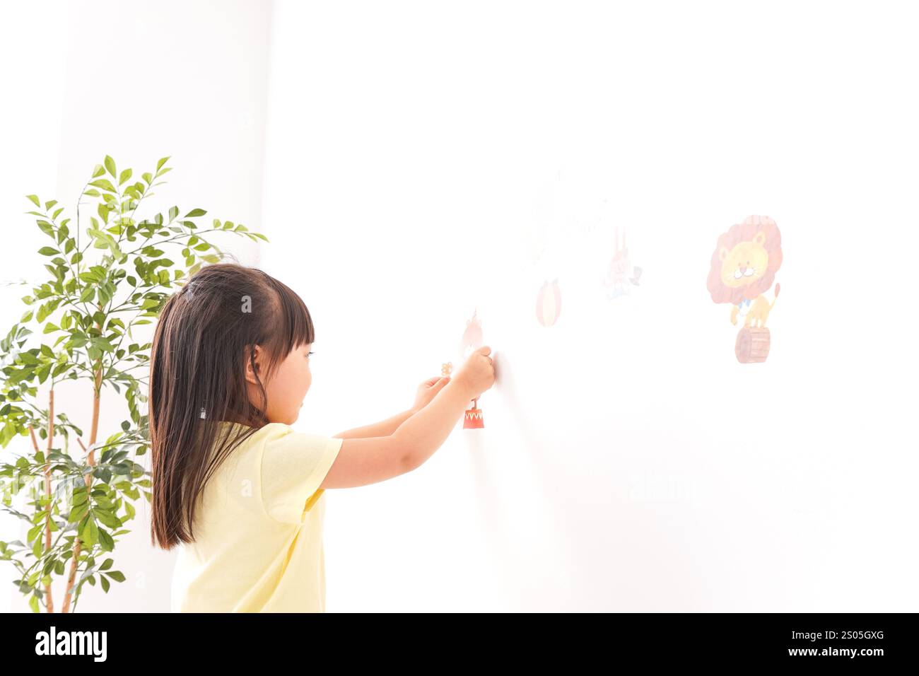 Child applying stickers Stock Photo - Alamy