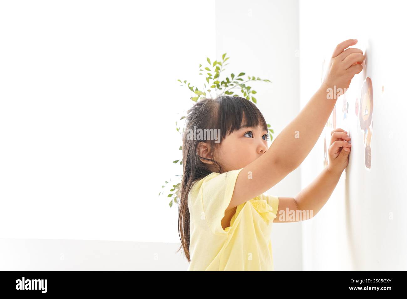Child applying stickers Stock Photo - Alamy