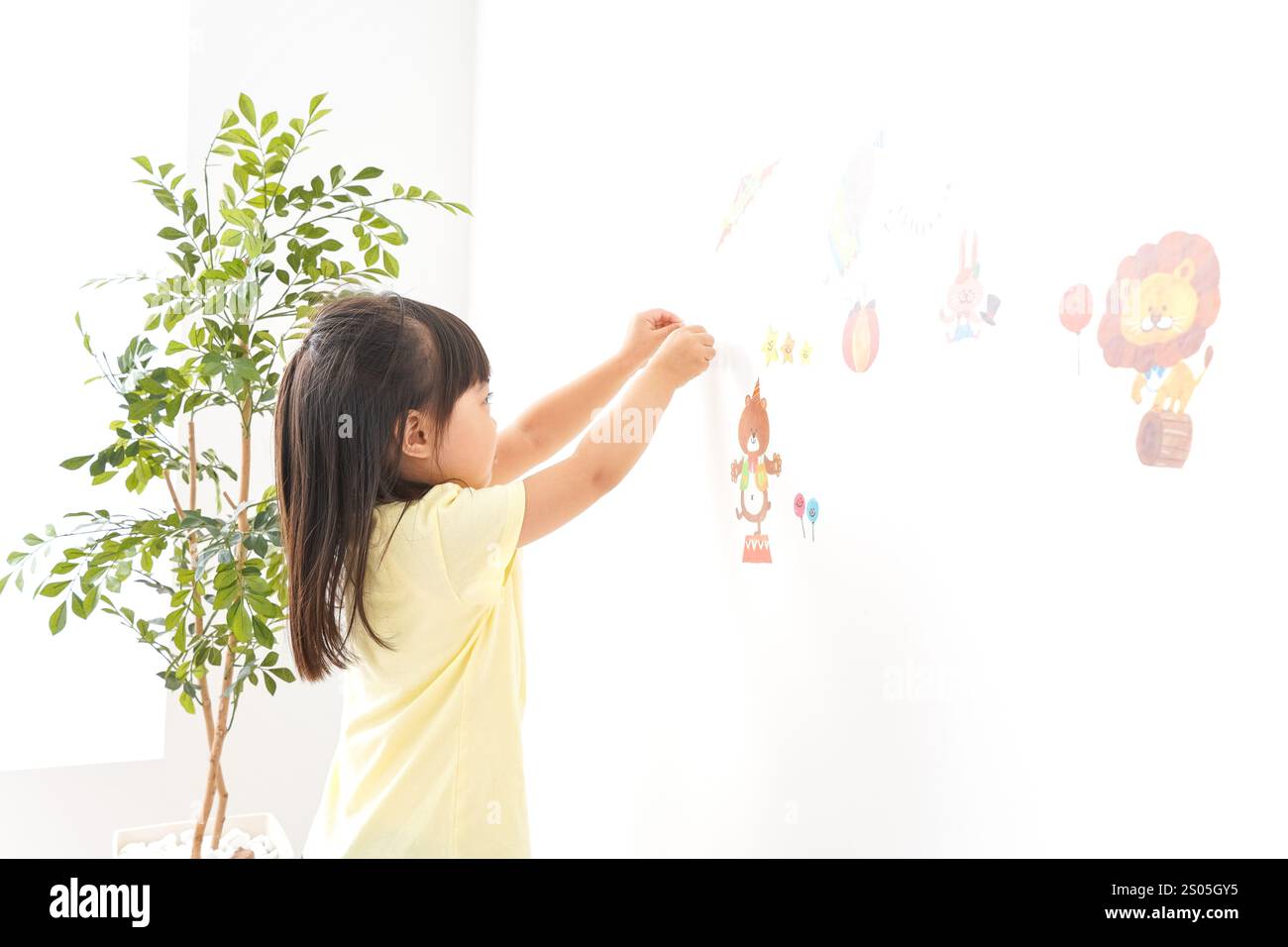 Child applying stickers Stock Photo - Alamy