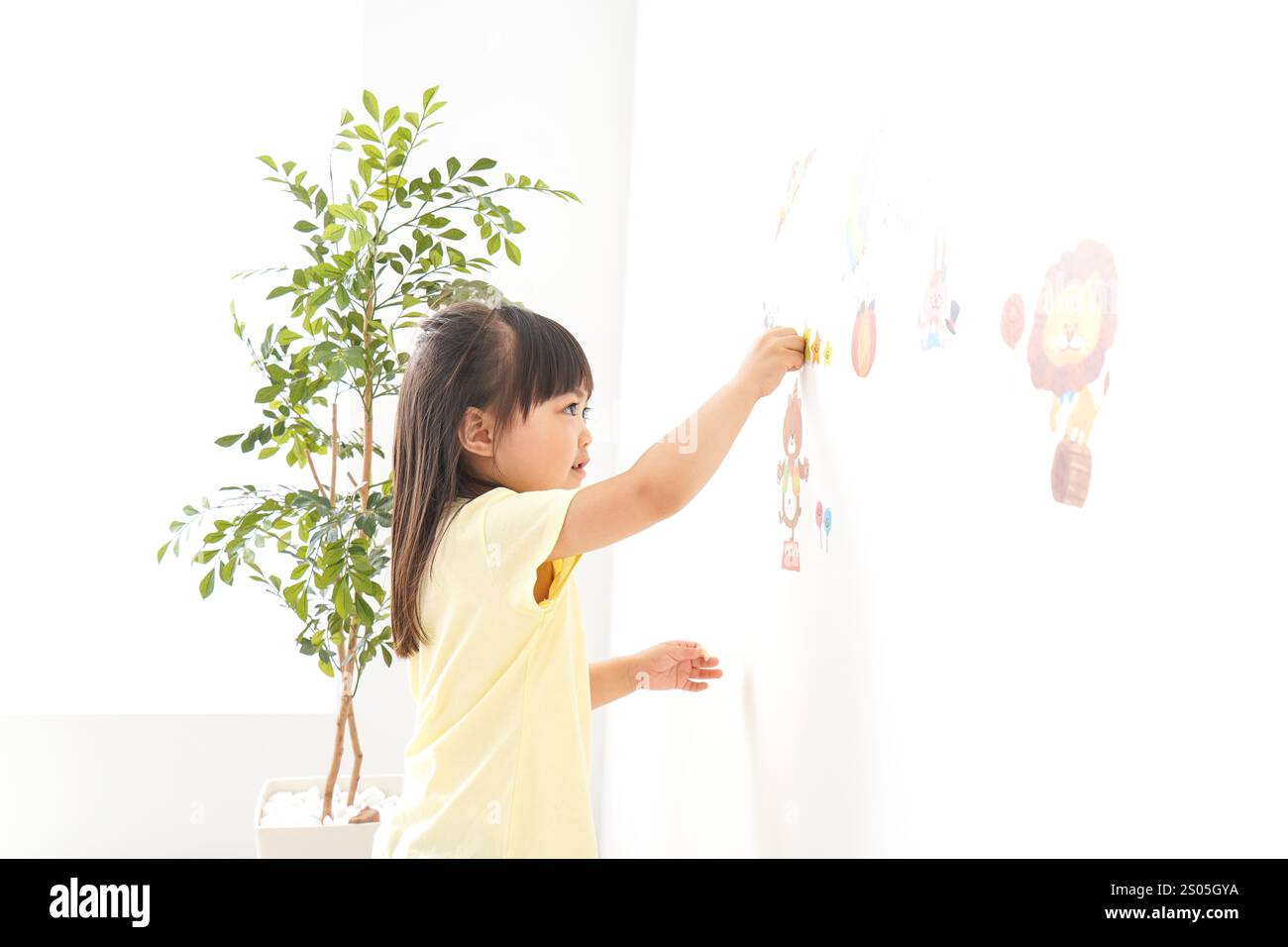 Child applying stickers Stock Photo - Alamy