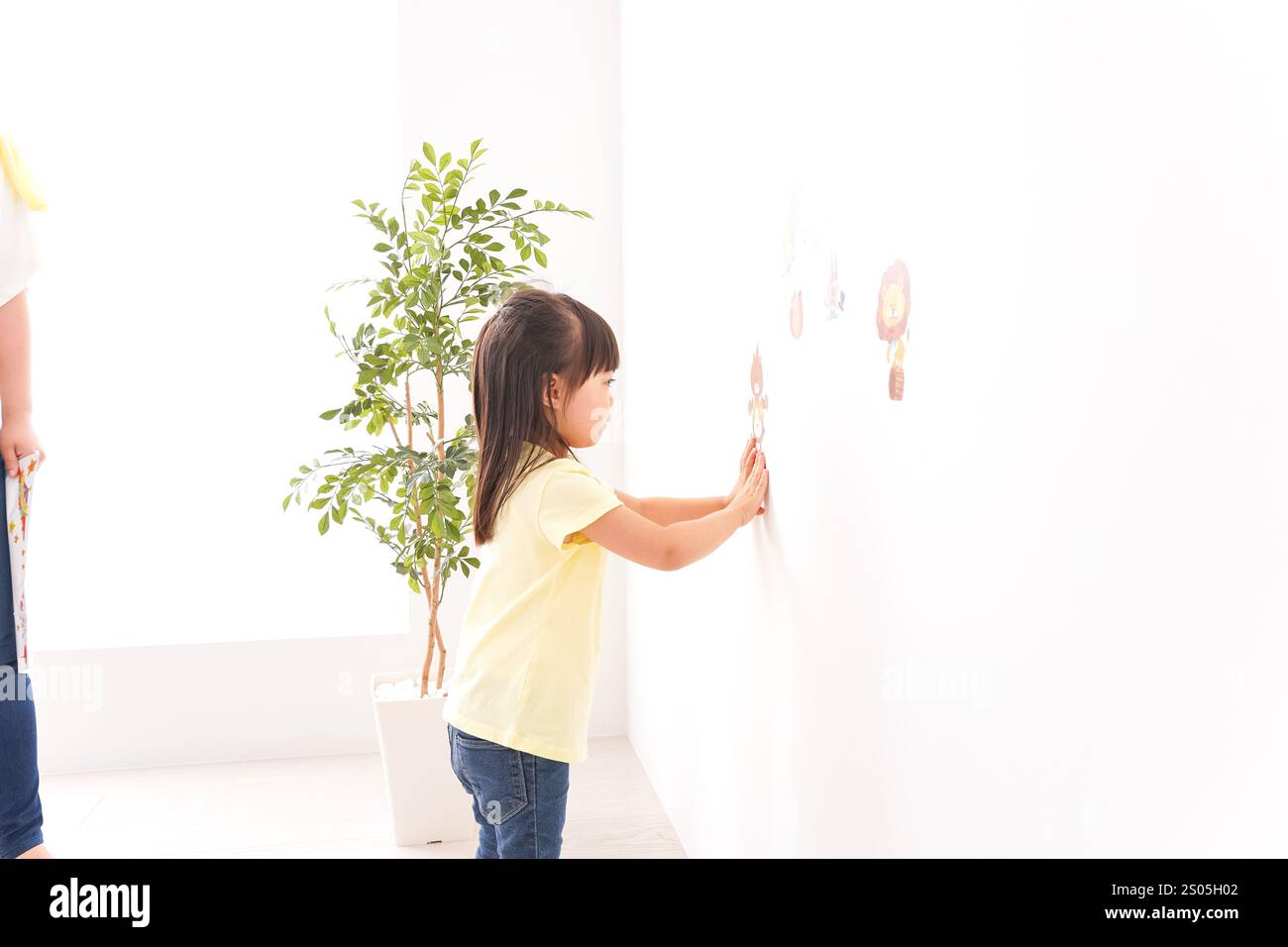 Child applying stickers Stock Photo - Alamy