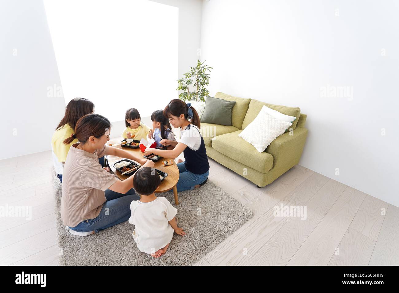 Children eating rice with their mothers Stock Photo - Alamy