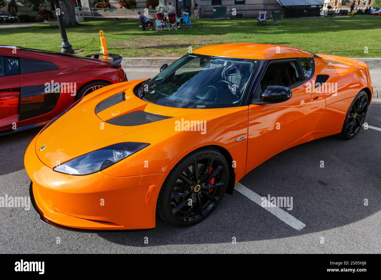 An orange Lotus Evora sports car on display at the Fast and Fabulous ...