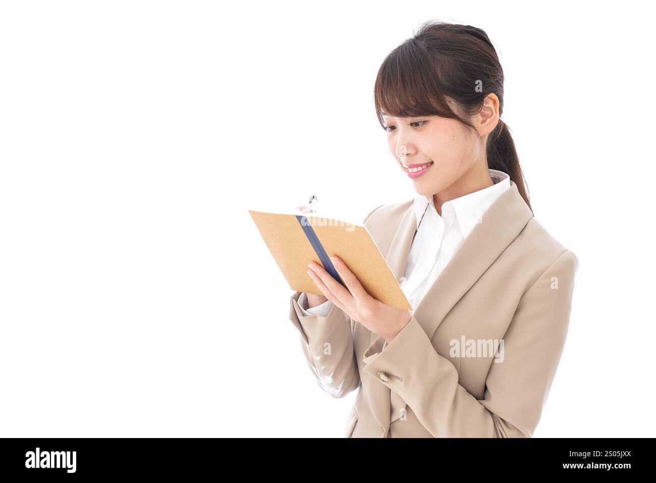 Woman writing while thinking Stock Photo - Alamy