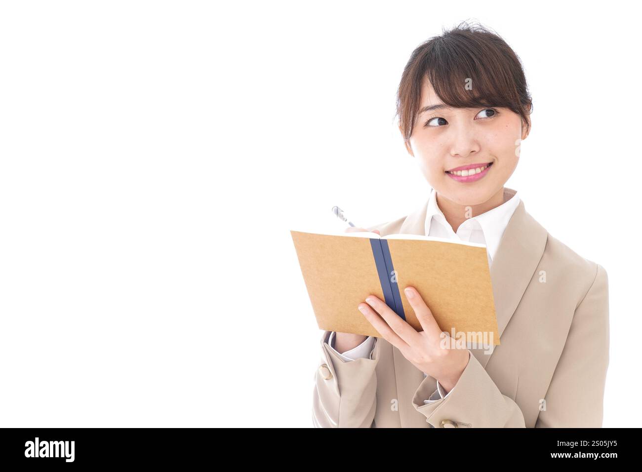 Woman writing while thinking Stock Photo - Alamy