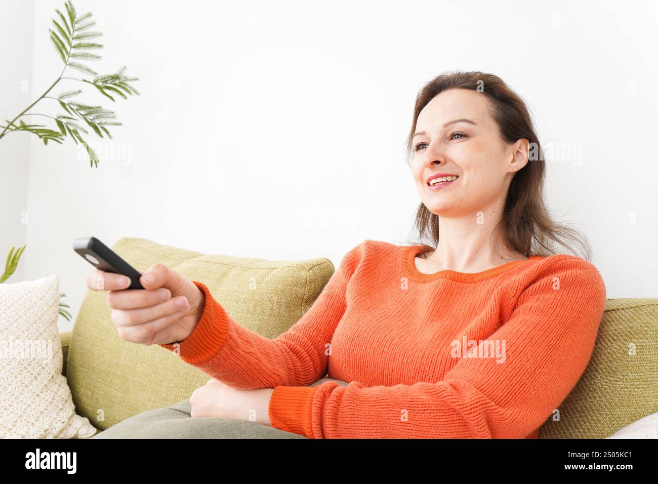 Young women watching TV at home Stock Photo - Alamy