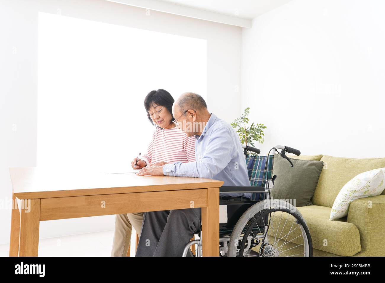 Elderly couple signing a contract Stock Photo - Alamy