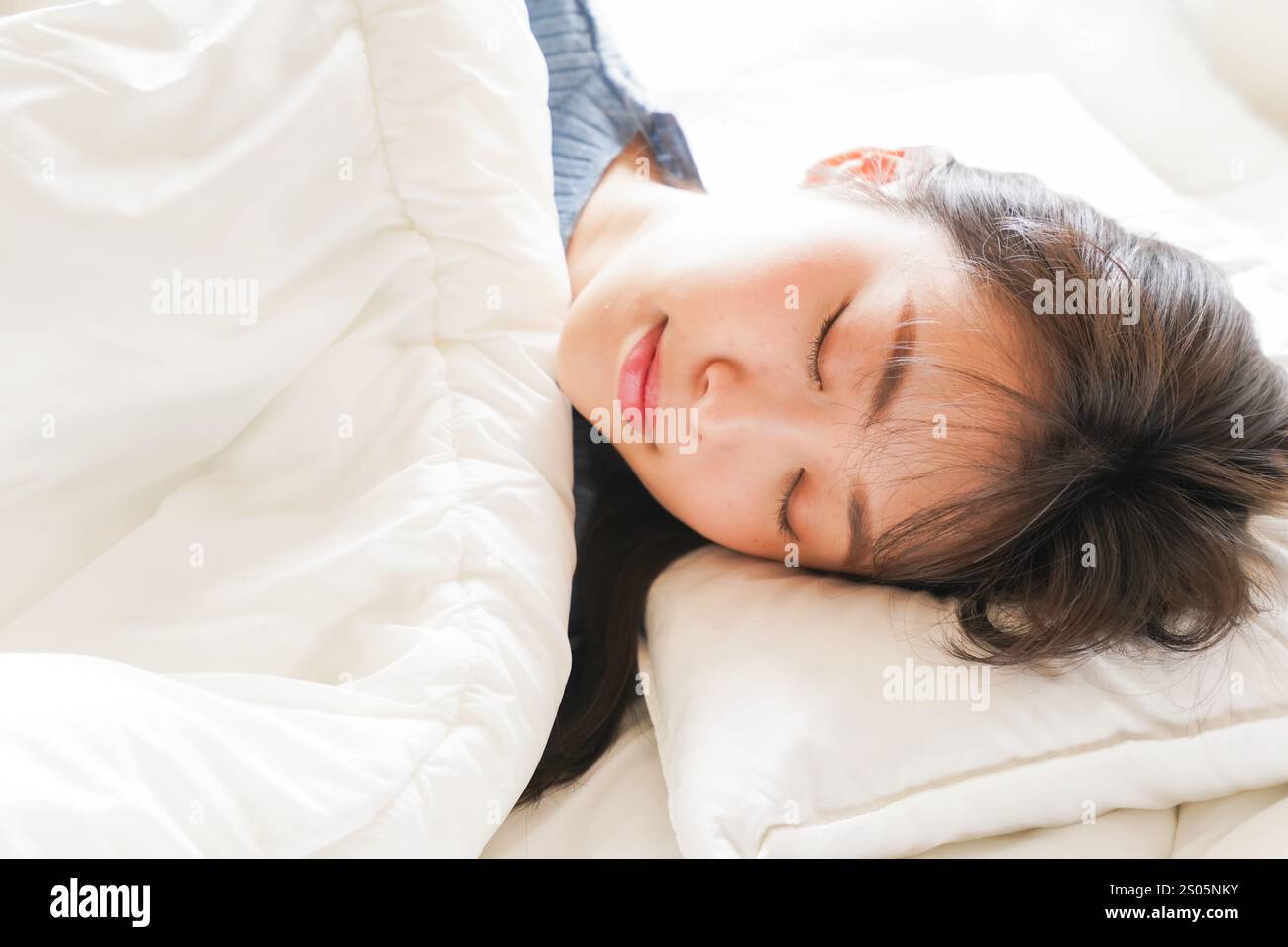 Young woman sleeping in a futon Stock Photo - Alamy