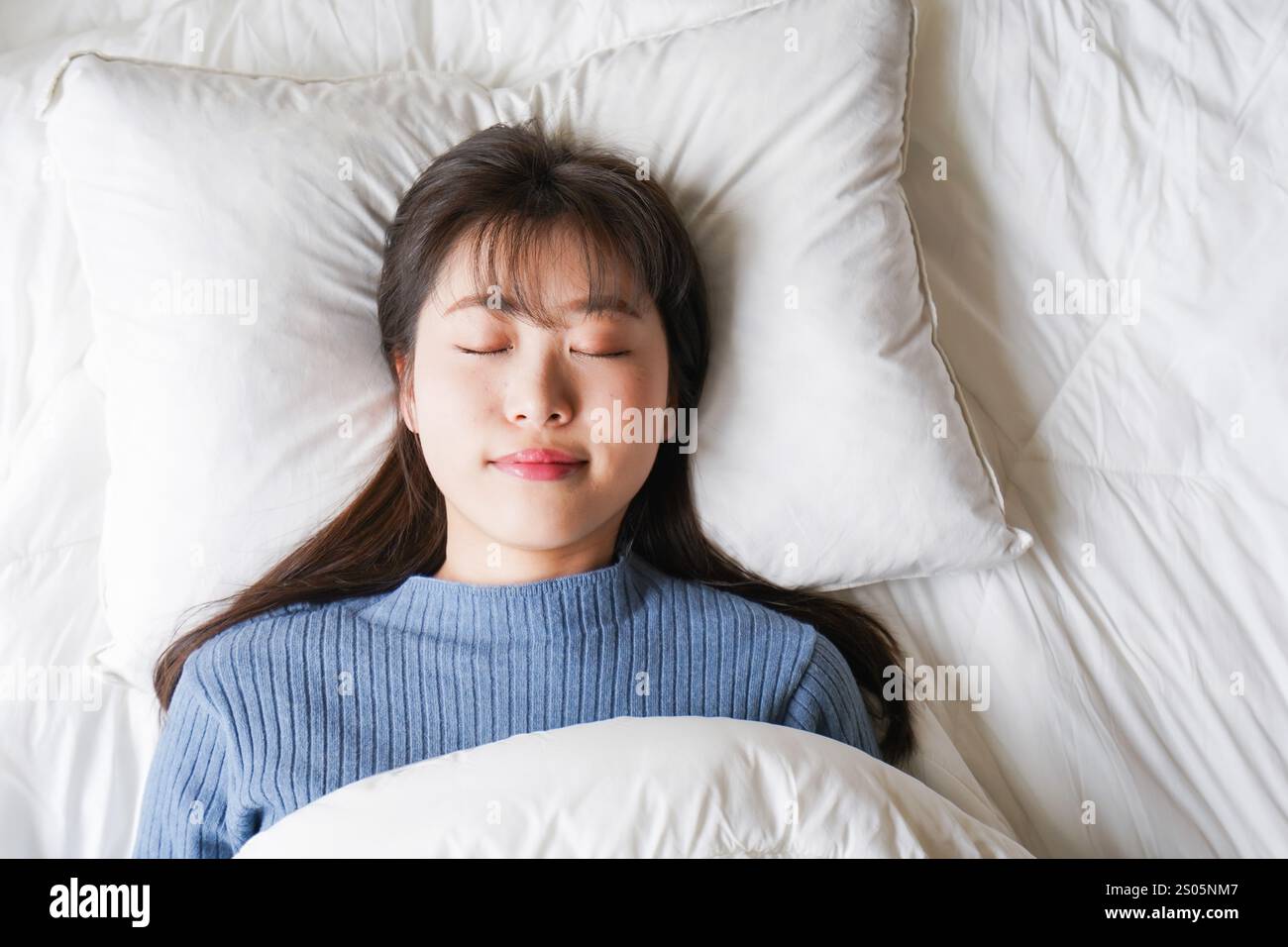 Young woman sleeping in a futon Stock Photo - Alamy