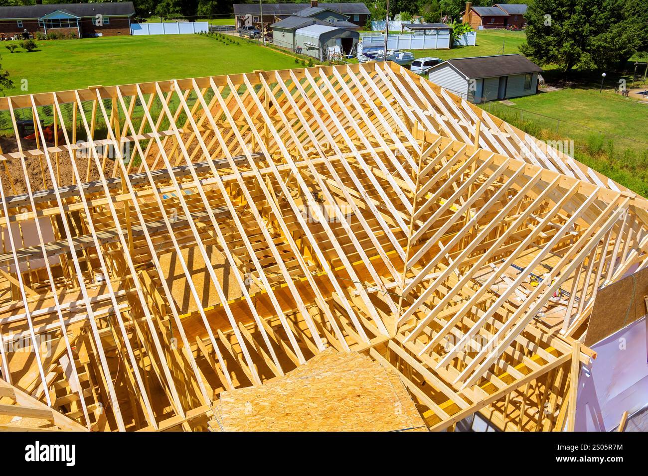 Detailed view shows framework of wooden roof under construction with ...