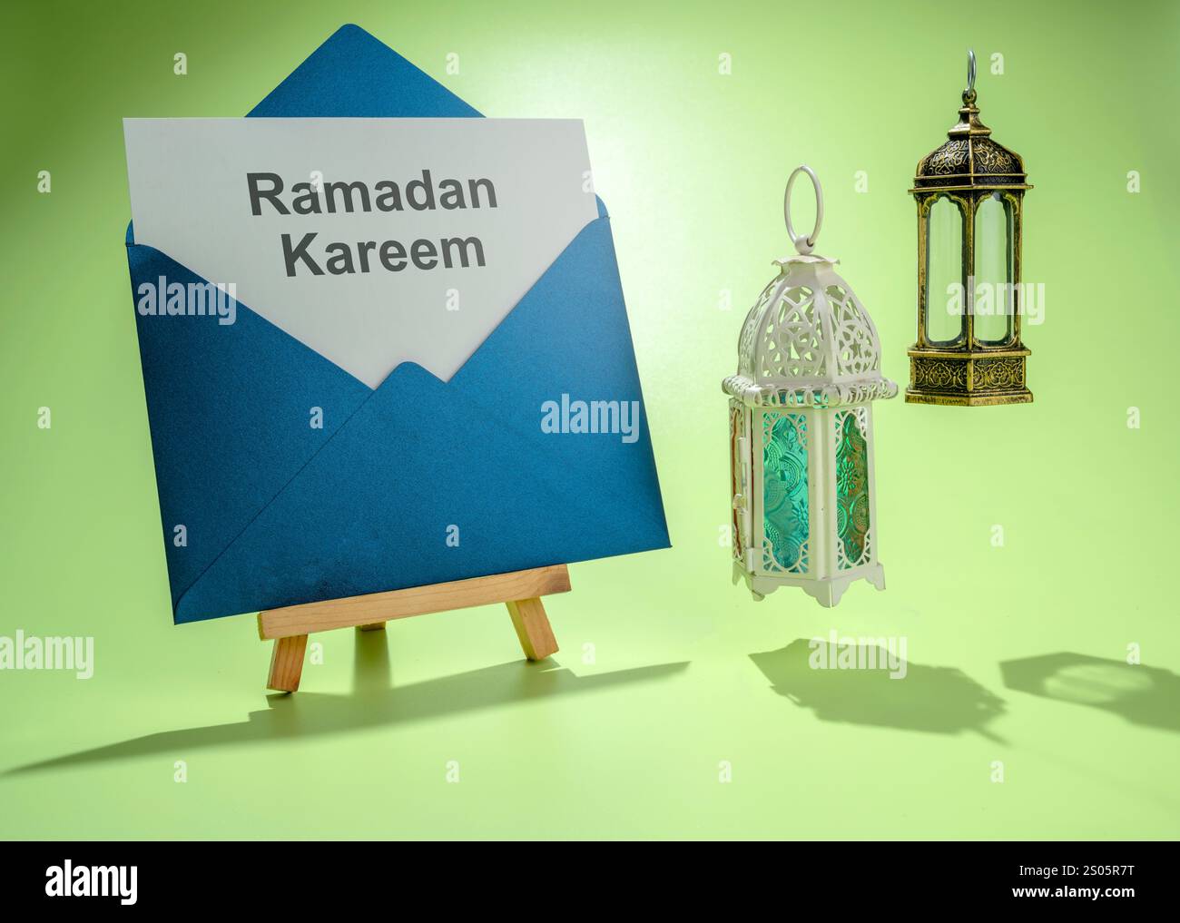 Wooden easel and envelope with text of Ramadan Kareem and Arabic ...