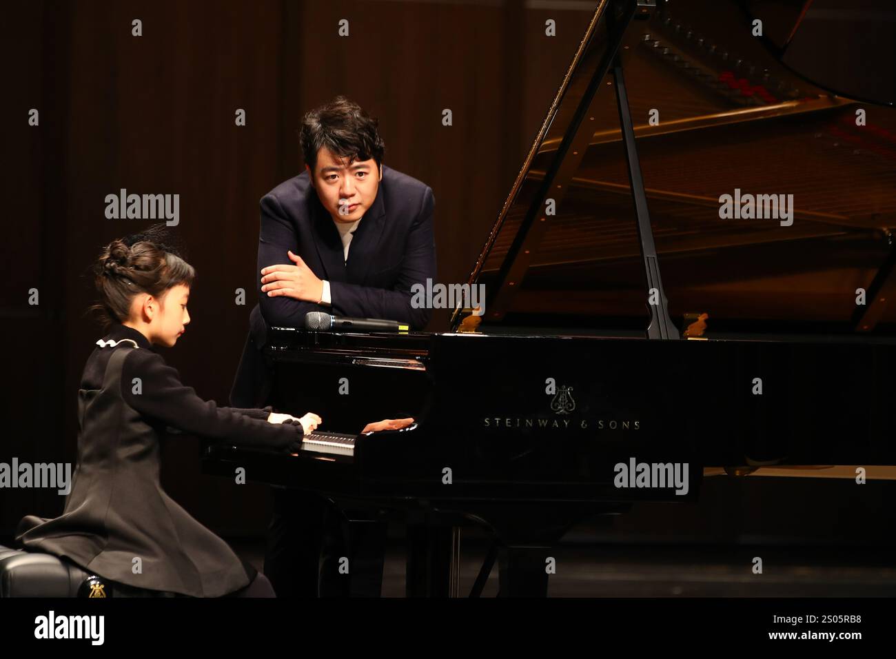 Nanchang,China.24th December 2024. Pianist Lang Lang guides the child ...