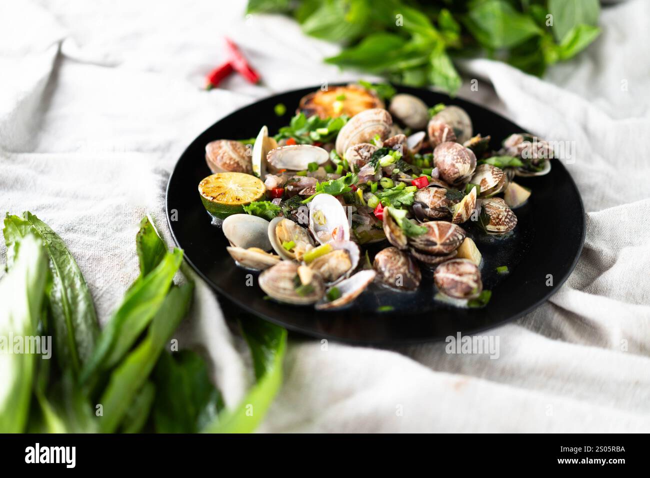A colorful seafood dish of clams and mussels garnished with garlic and ...