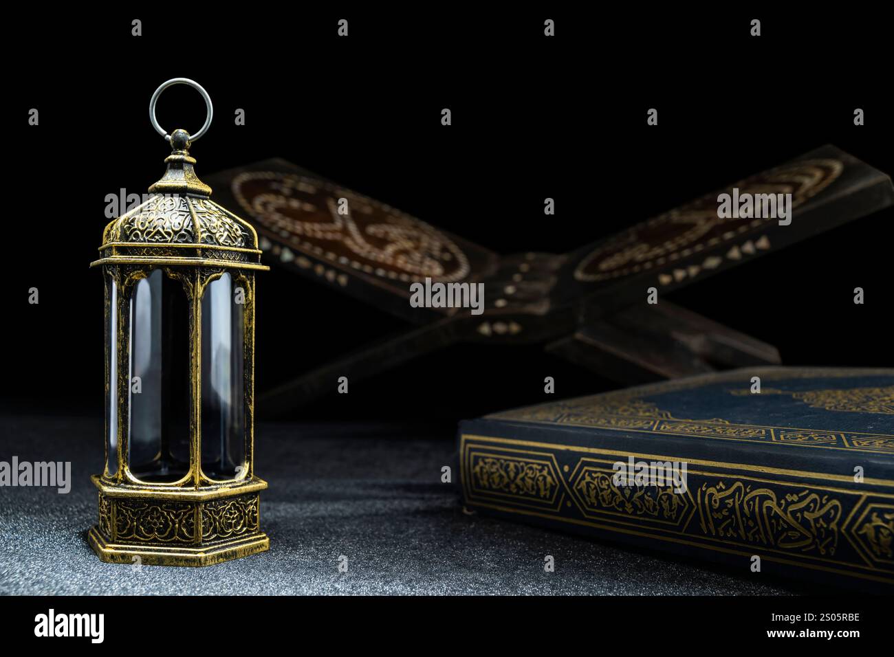 Arabic lantern with Quran and Quran matt on a black background ...