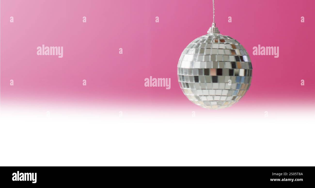 Image of disco ball spinning on pink background. New year's eve ...