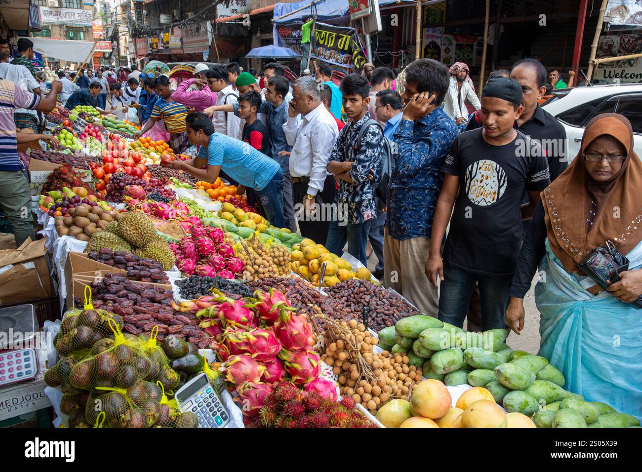 Customers gather at roadside fruit shops in Purana Paltan, Dhaka, where a variety of imported ...