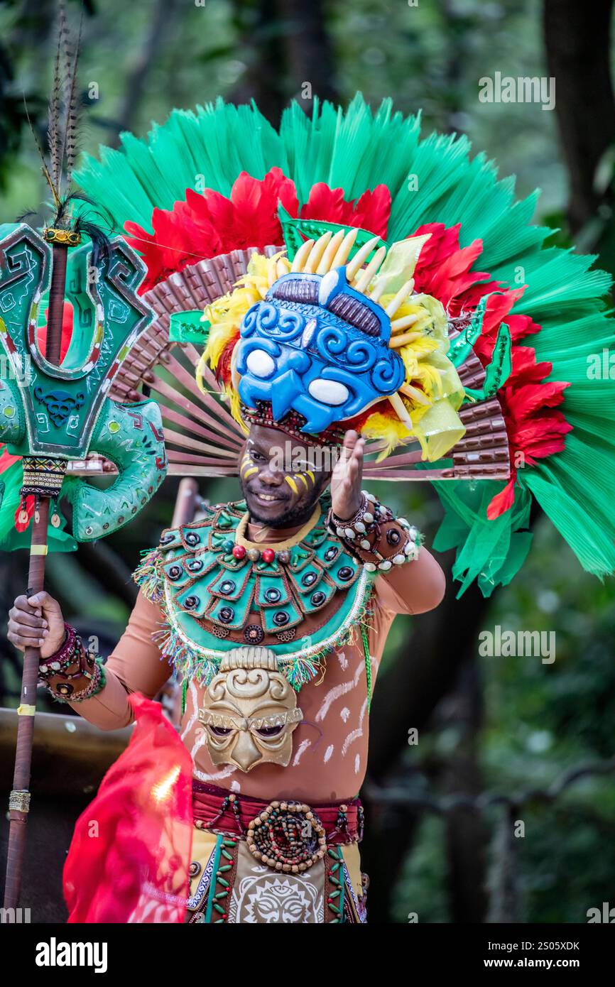 An African actor dressed as an African tribal chief waves and greets ...