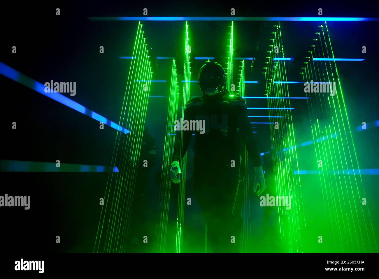 Seattle Seahawks defensive end Mike Morris walks through lasers in the ...