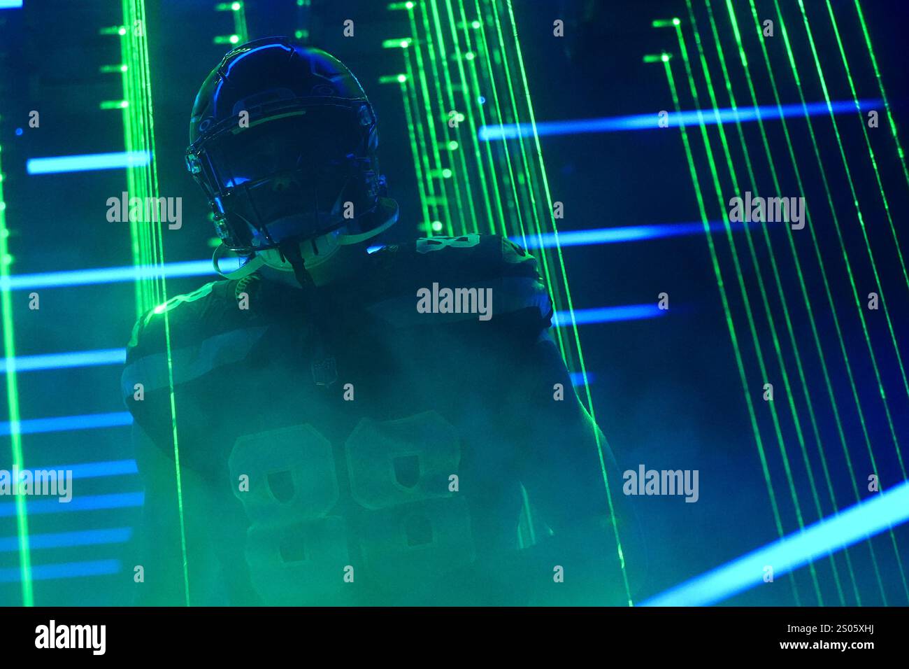 Seattle Seahawks tight end AJ Barner walks through a tunnel lit by ...