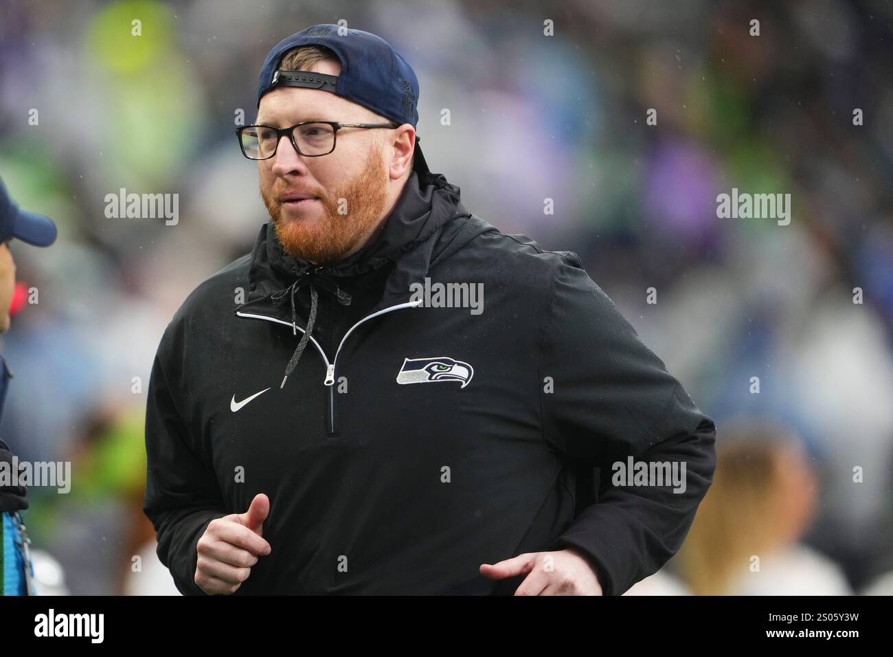 Seattle Seahawks special teams coordinator Jay Harbaugh jogs off the ...