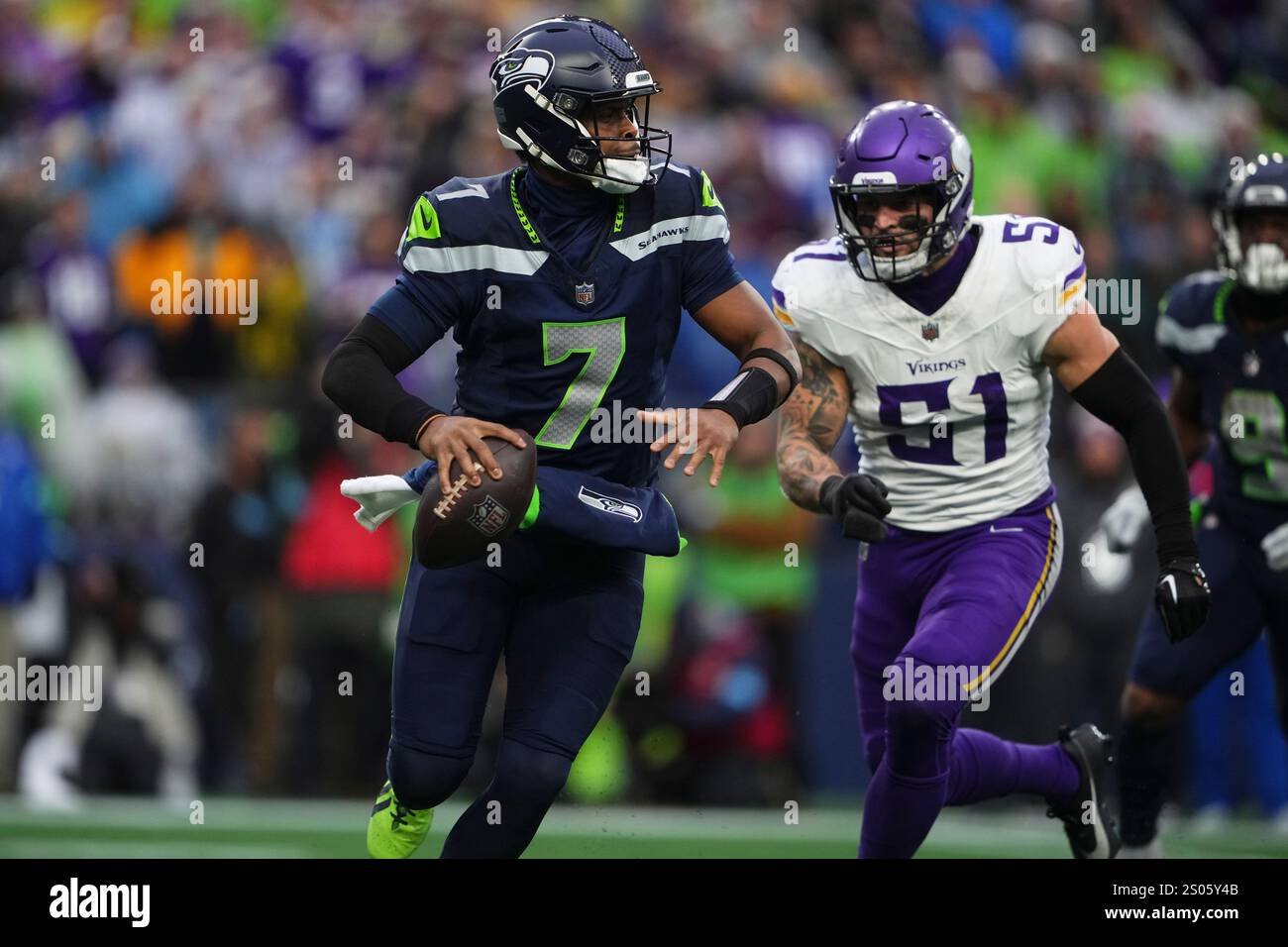Seattle Seahawks quarterback Geno Smith runs the ball while being ...