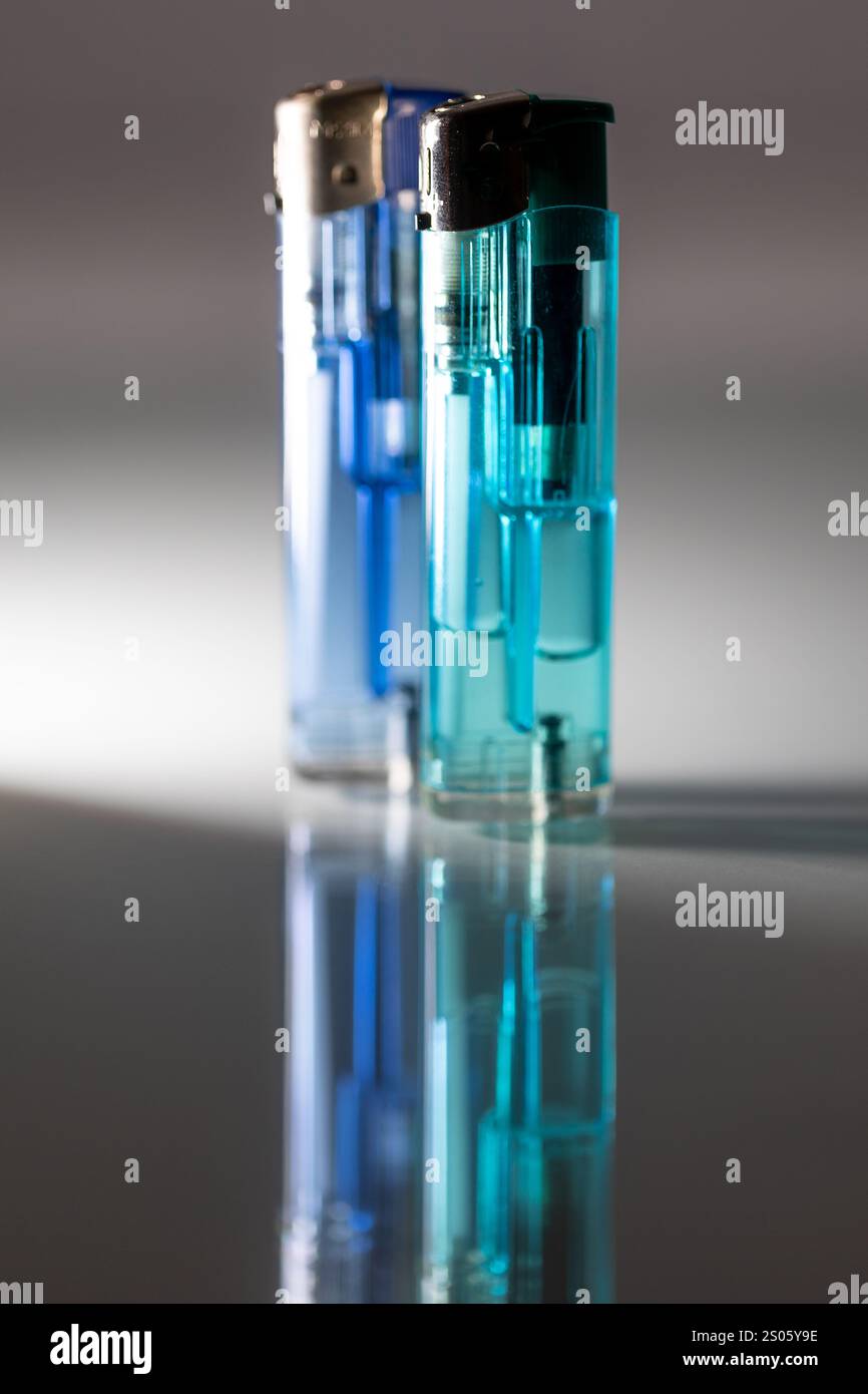 Two lighters in vibrant dark and light blue shades stand side by side ...
