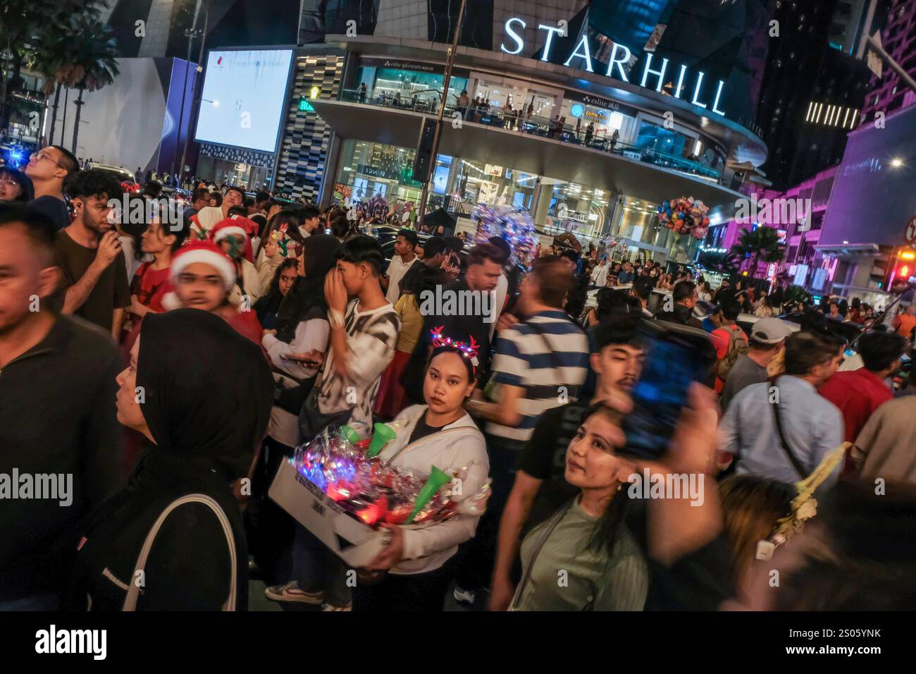 Kuala Lumpur, Malaysia. 24th Dec, 2024. A party toy seller seen with ...