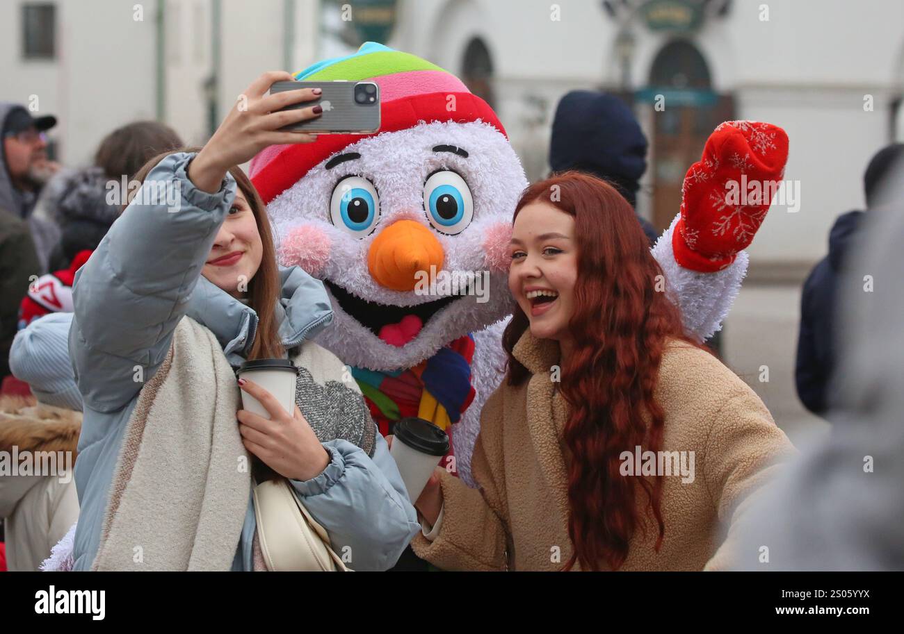 Minsk, Belarus. 24th Dec, 2024. People take selfies with an actor ...