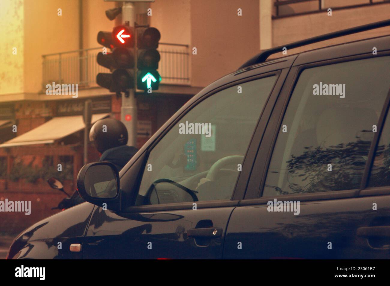 Traffic lights at intersection with cars and moped in Italy Stock Photo ...
