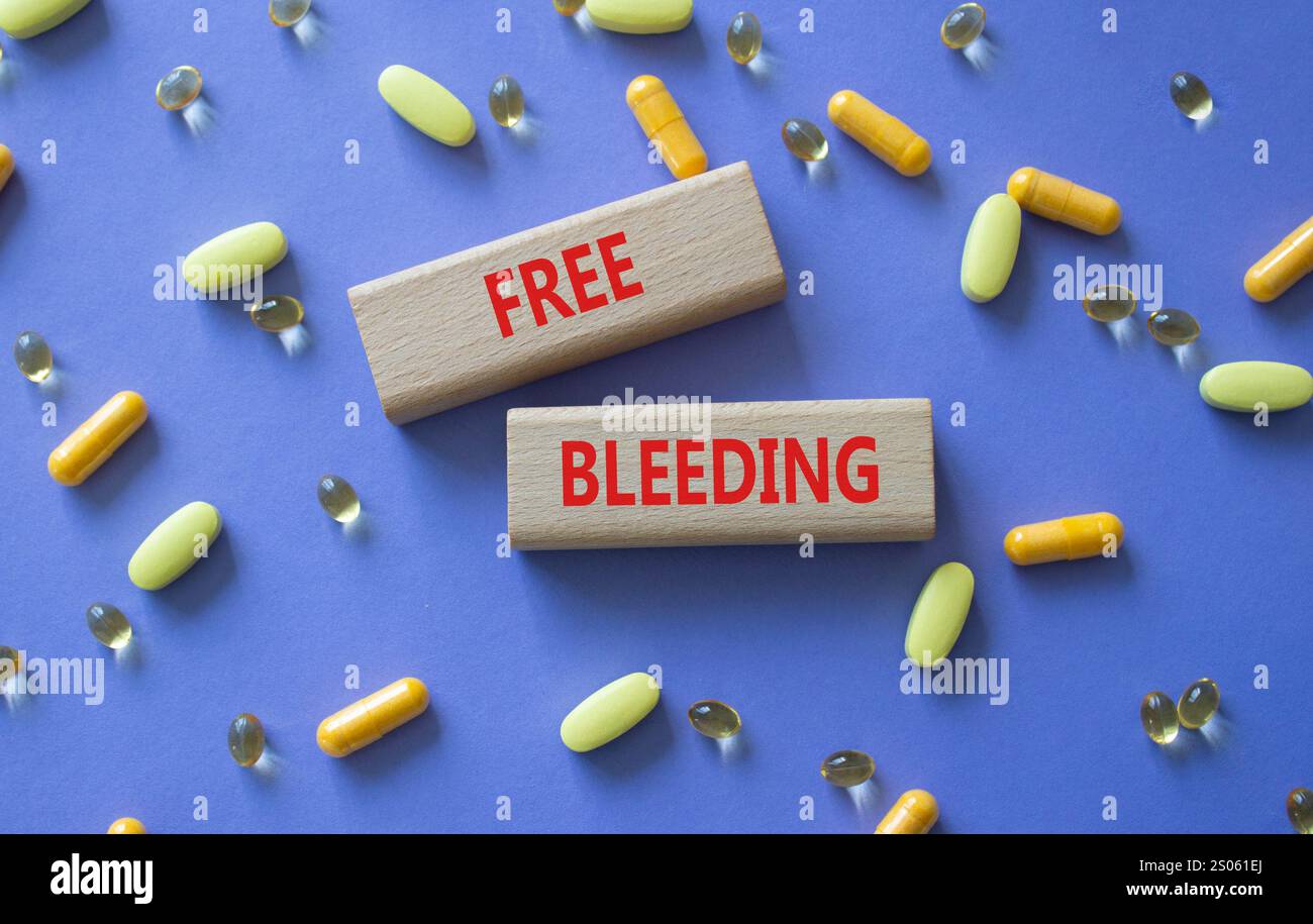 Free bleeding symbol. Concept words Free bleeding on wooden blocks ...