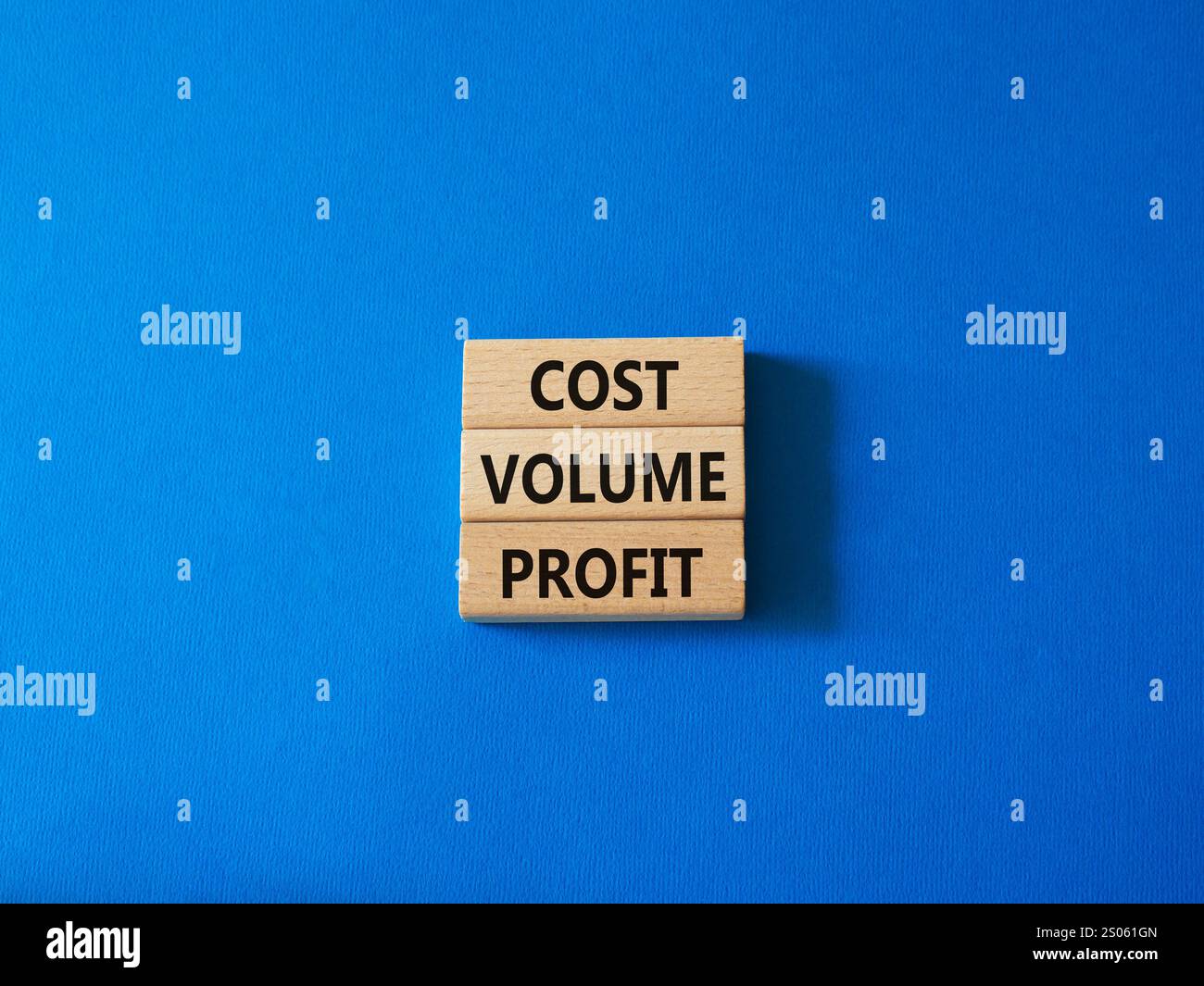 Cost Volume Profit symbol. Concept word Cost Volume Profit on wooden blocks. Beautiful blue ...
