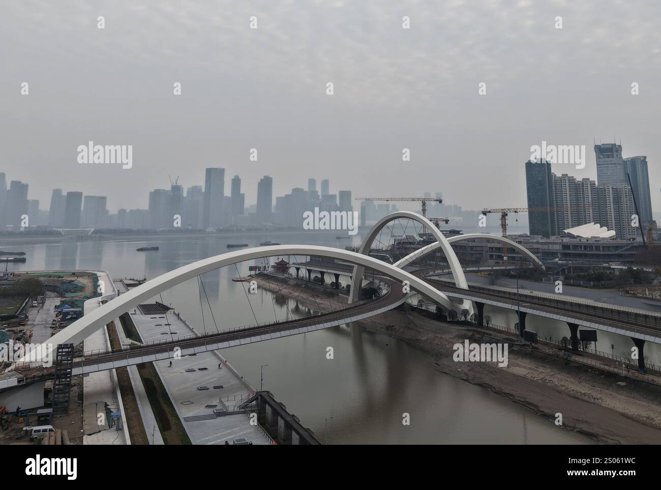 HANGZHOU, CHINA - DECEMBER 25, 2024 - A scenic pedestrian bridge across ...