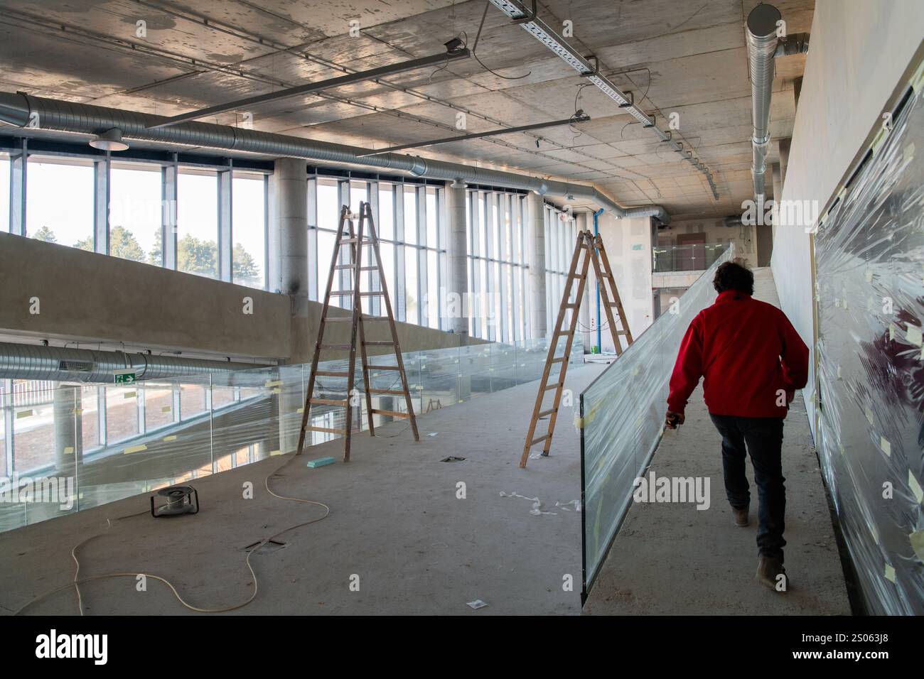 An engineer walks through the construction site, carefully inspecting ...