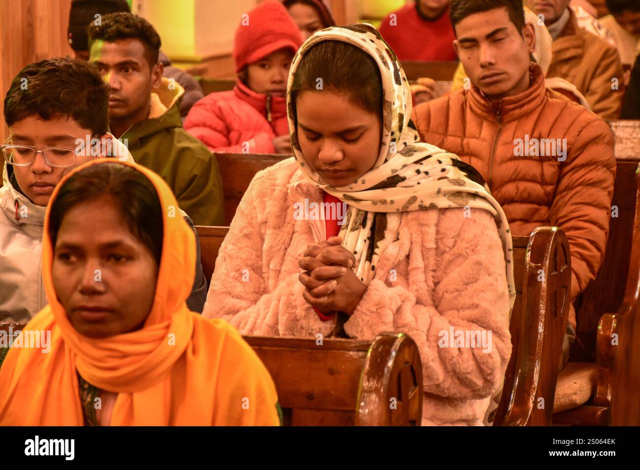Srinagar, India. 25th Dec, 2024. A Christian devotee prays inside the ...