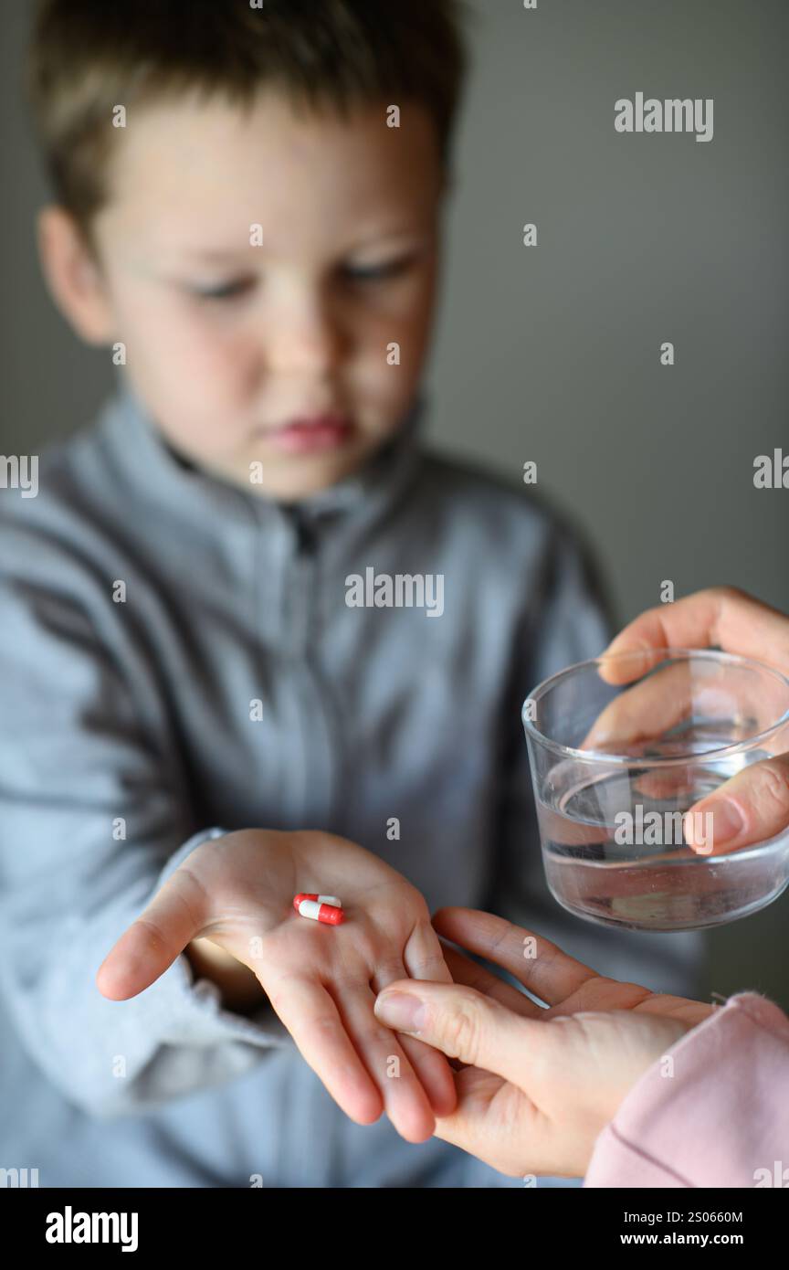 kid is going to take a pill of supplement Stock Photo - Alamy