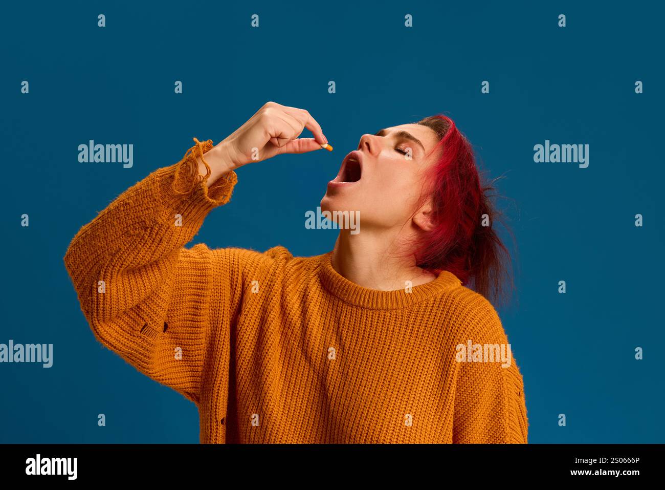 Woman taking yellow pill, symbolizing self-treatment to manage viral ...