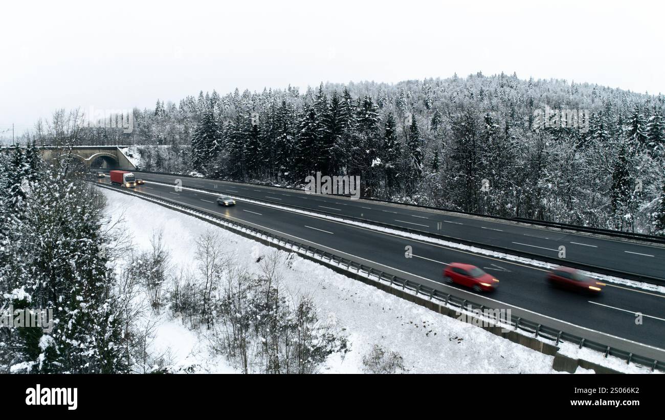 Snowy Highway with Cars and a Tunnel in Winter Stock Photo - Alamy