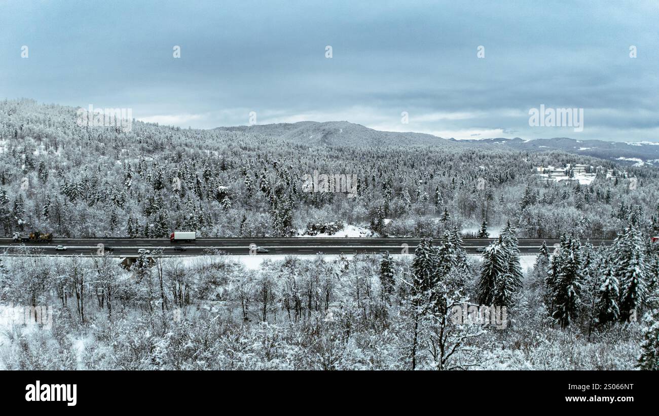 Aerial View of Snowy Highway Through a Winter Forest Valley Stock Photo ...