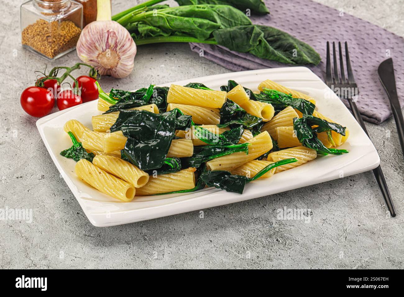 Italian cuisine - pasta tortiglioni with spinach Stock Photo - Alamy