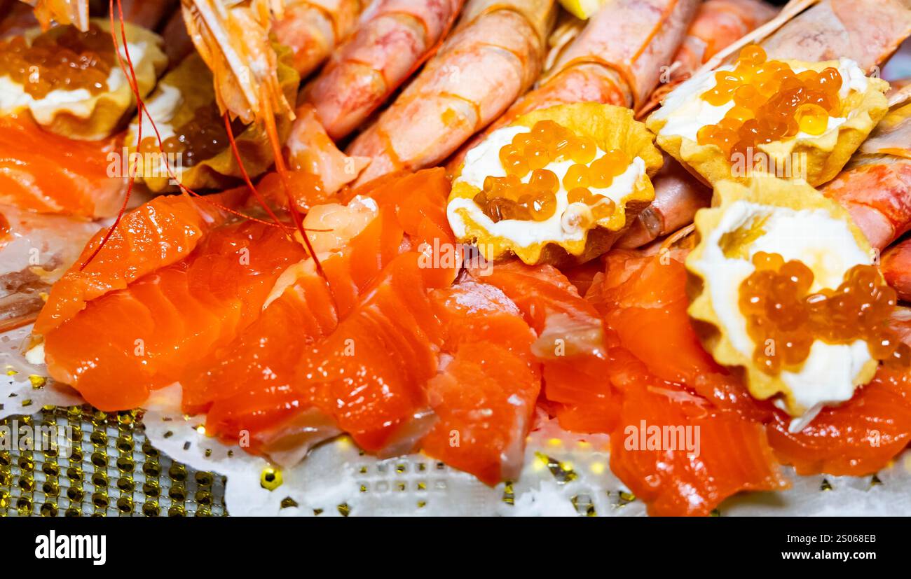 A vibrant seafood platter displays large, fresh shrimp alongside slices ...
