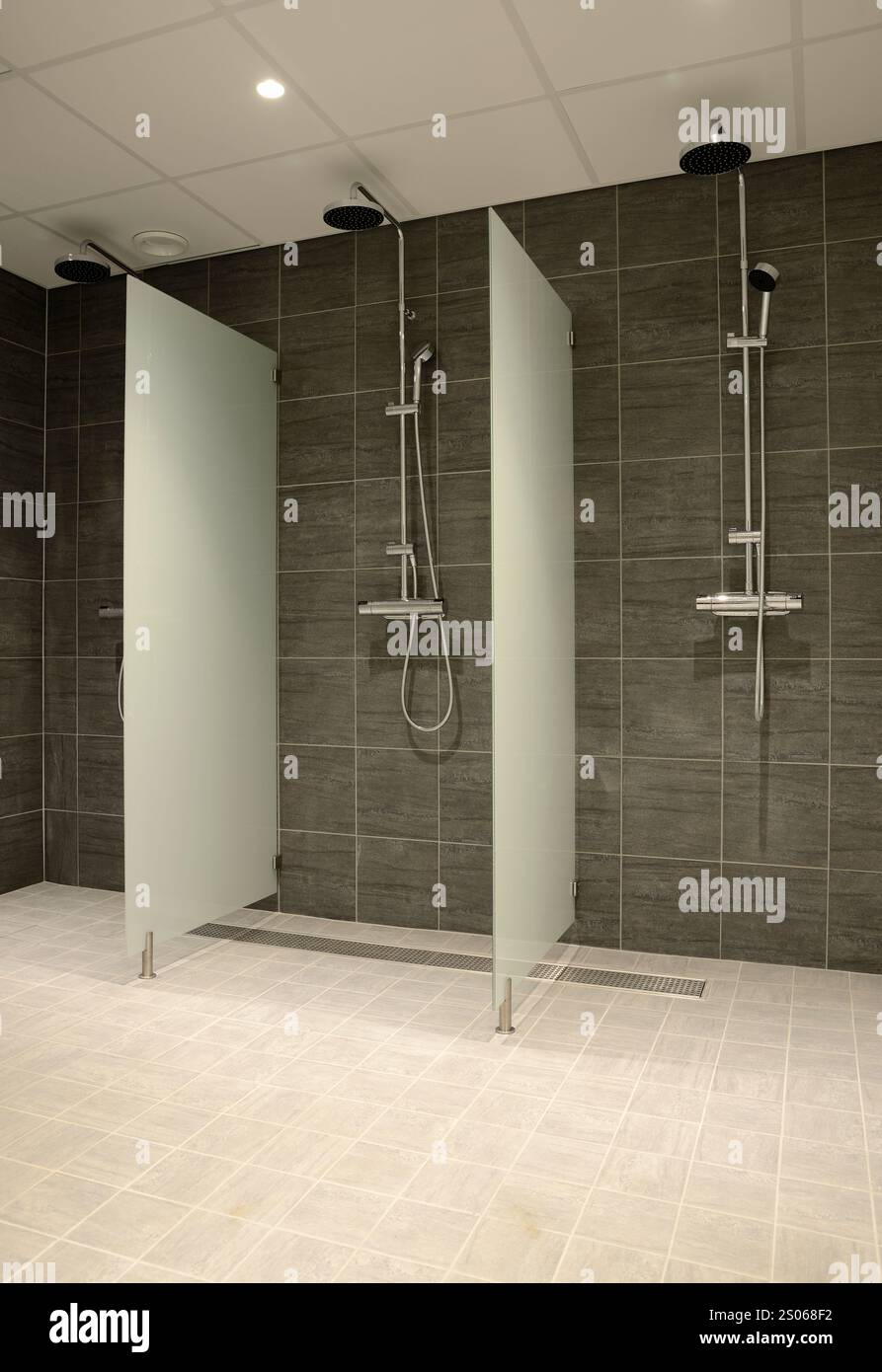 Three new empty showers Stock Photo - Alamy
