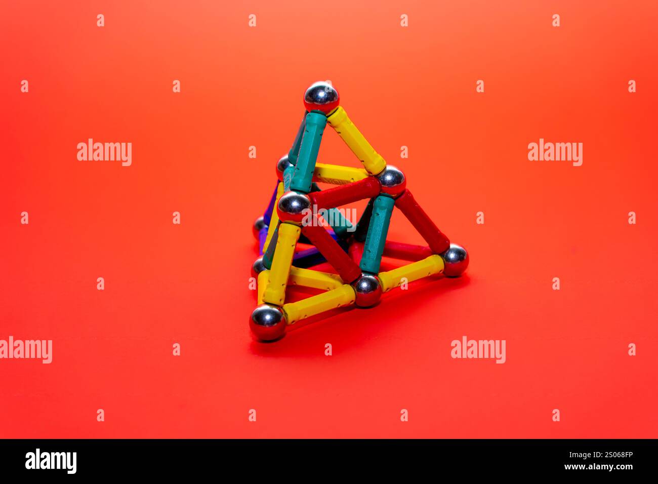 Brightly colored building sticks are assembled into a pyramid shape ...