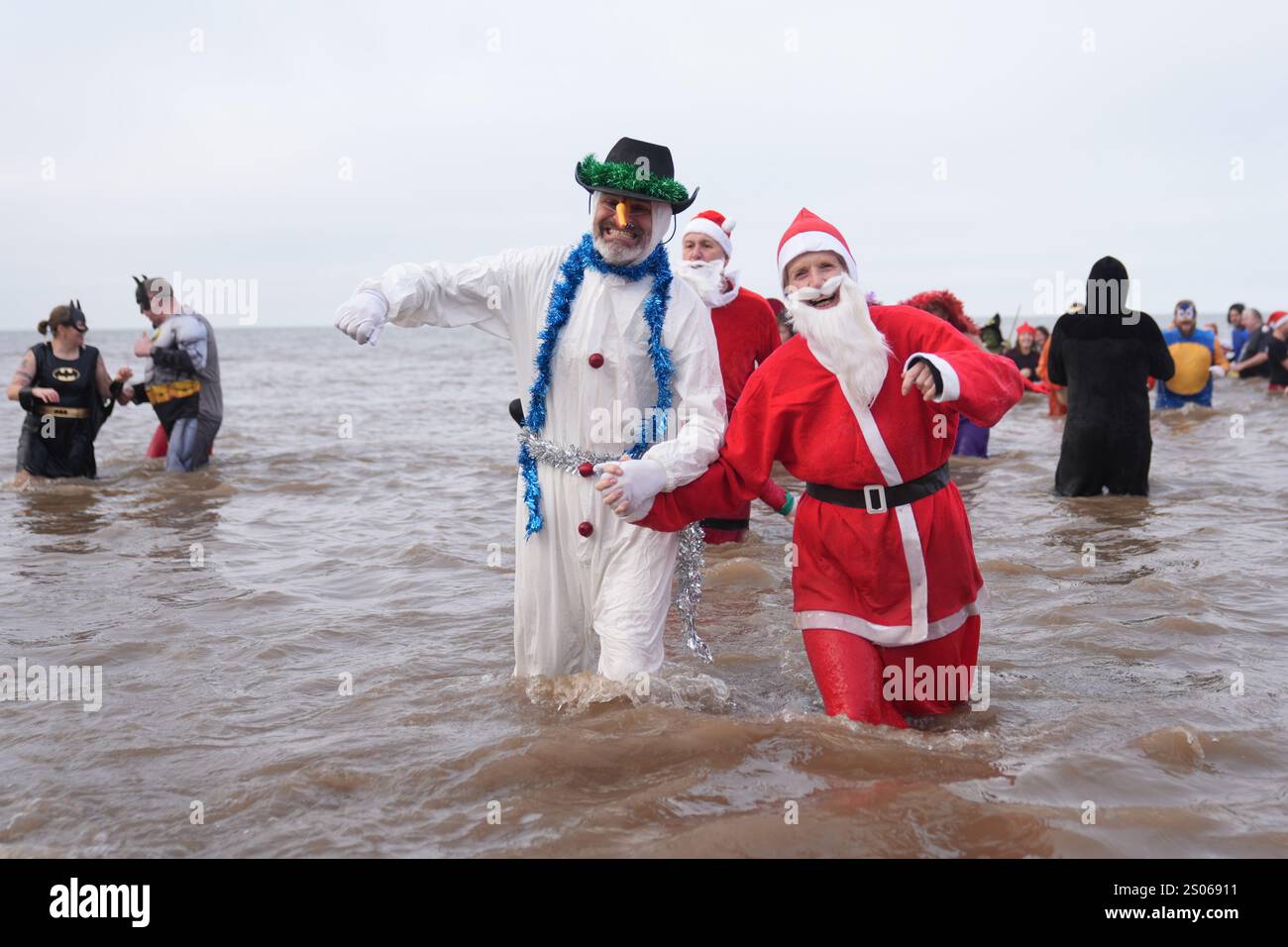 People take part in a Christmas Day dip at Hunstanton in Norfolk ...