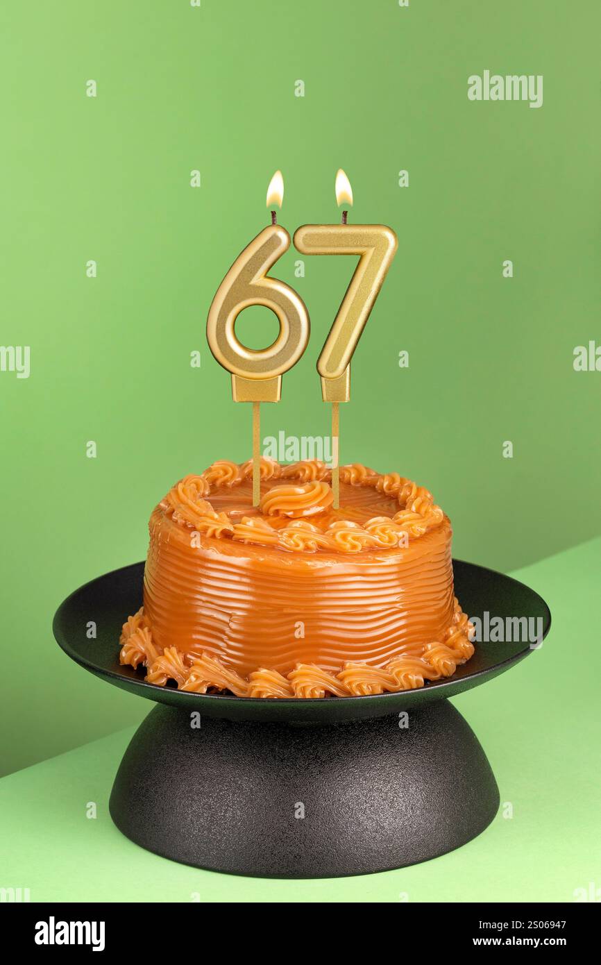 Number 67 birthday candle on a green background - Delicious cake with ...