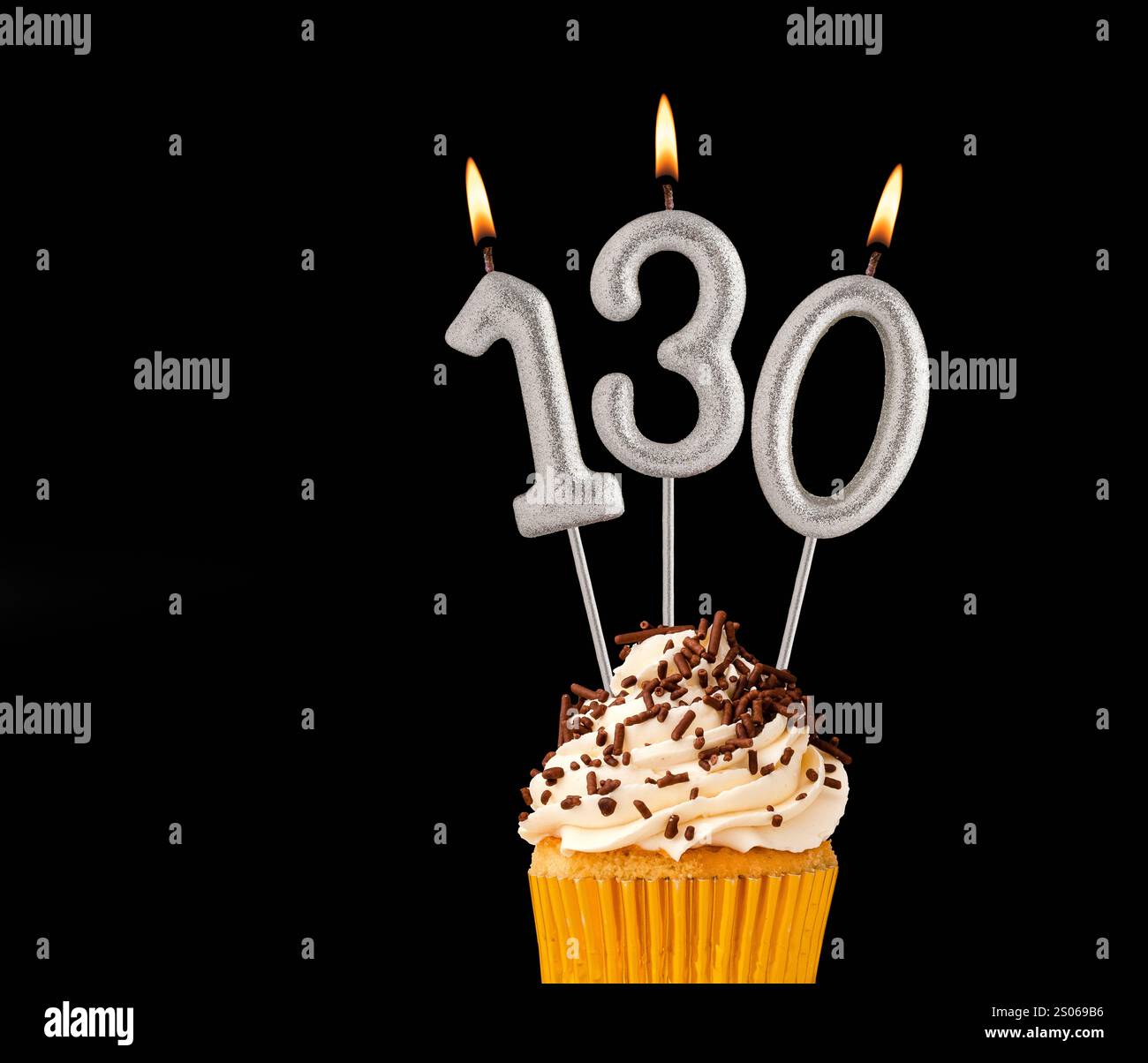 Number 130 shaped candles - Birthday cupcake on black background Stock ...
