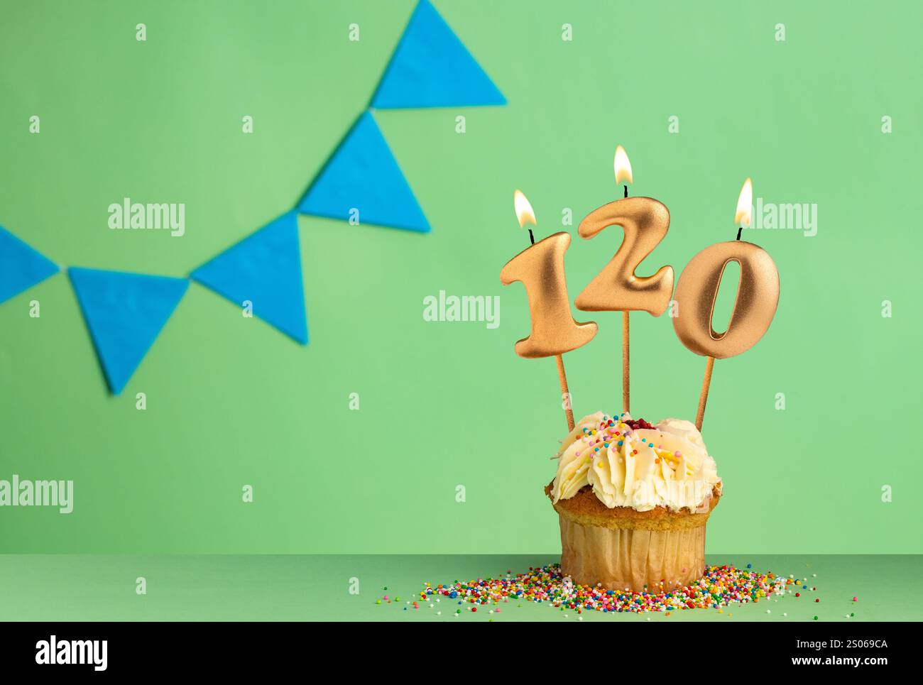 Birthday cupcake with number 120 candle - Green background with blue ...