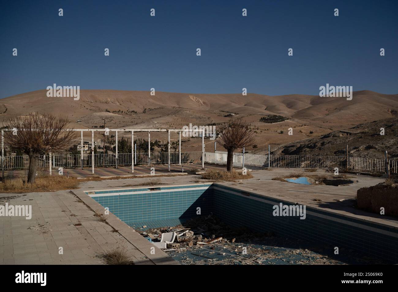 A pool at a damaged hotel during the morning in Maaloula, a village ...