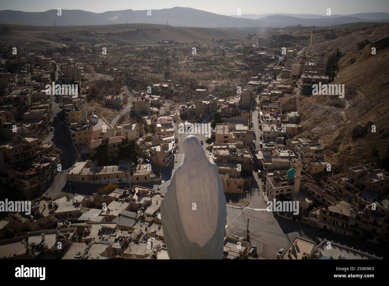 A statue of the Virgin Mary stands on the top of a cliff with a view of ...