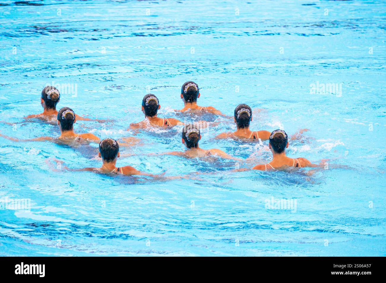Artistic swimmers team performing synchronized choreographed routine in ...