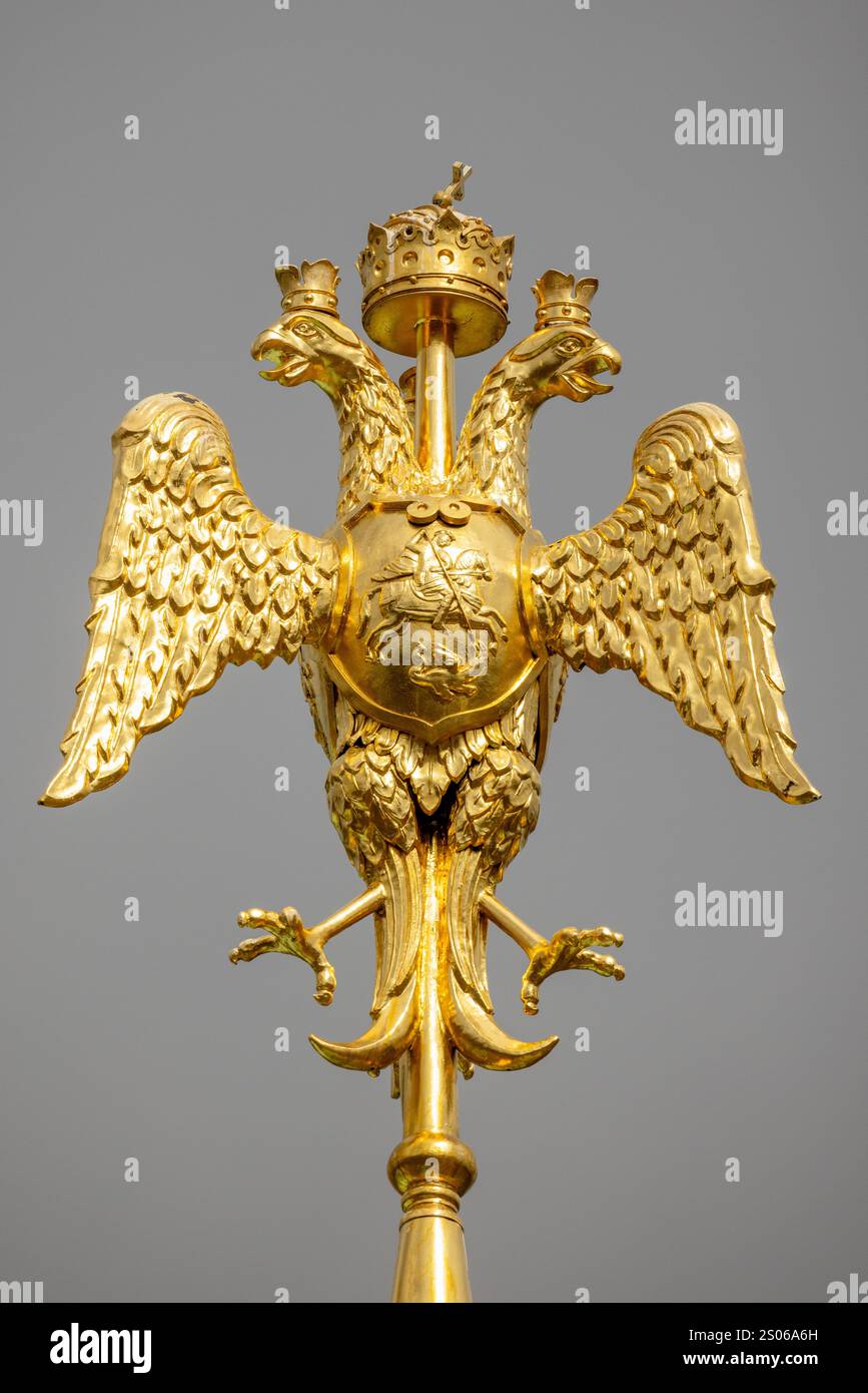 Two-headed eagle, Russian coat of arms is on dark gray sky background. Symbol of imperial Russia ...
